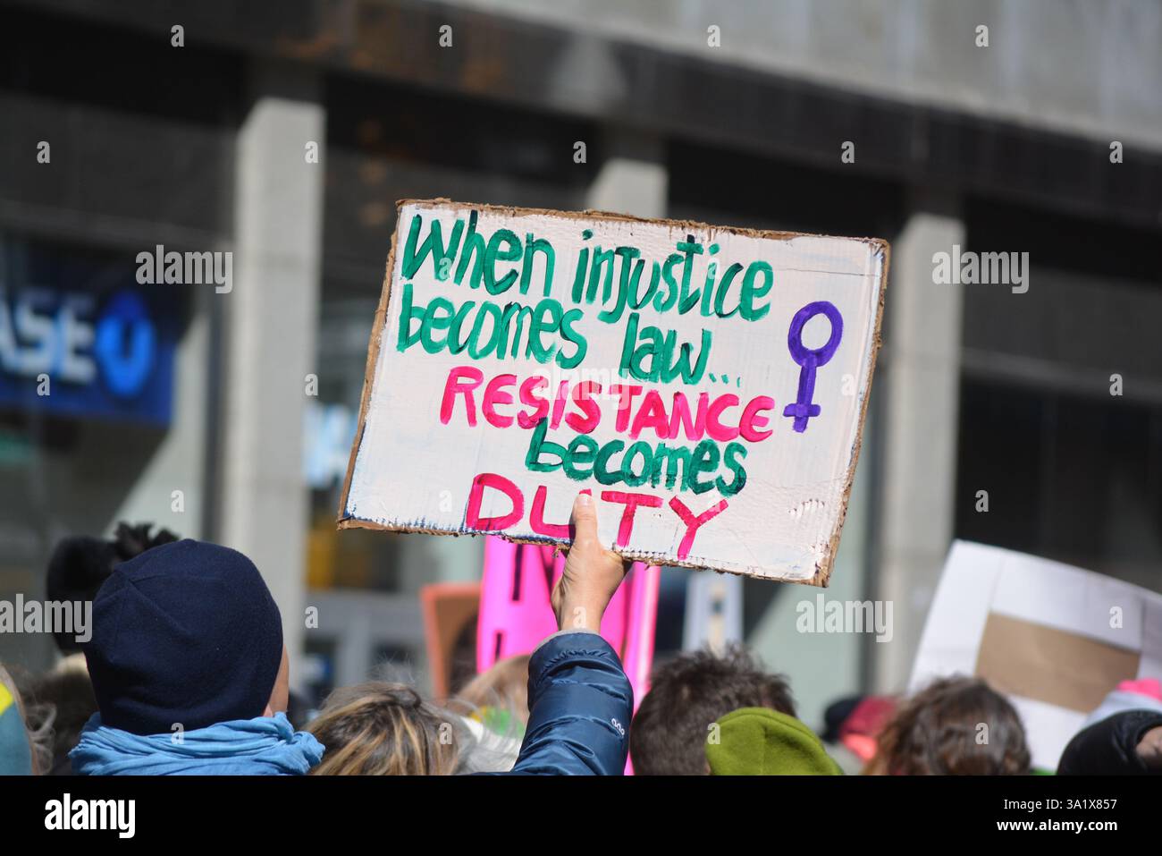 People holding signs at an International Women's Day march in New York ...