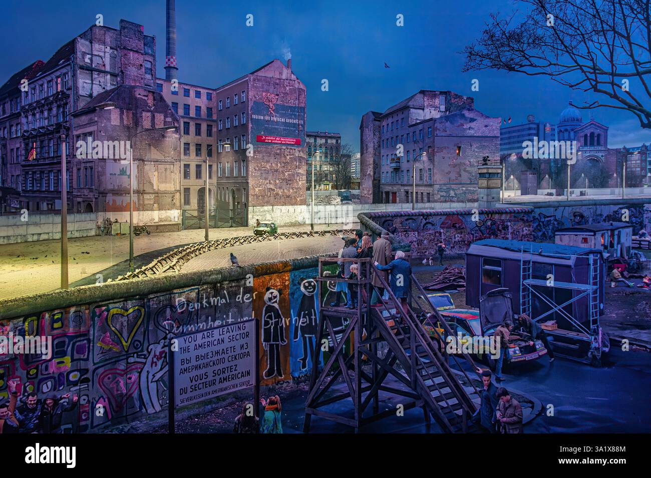 Tourists stand and observe the colorful graffiti decorating the ...