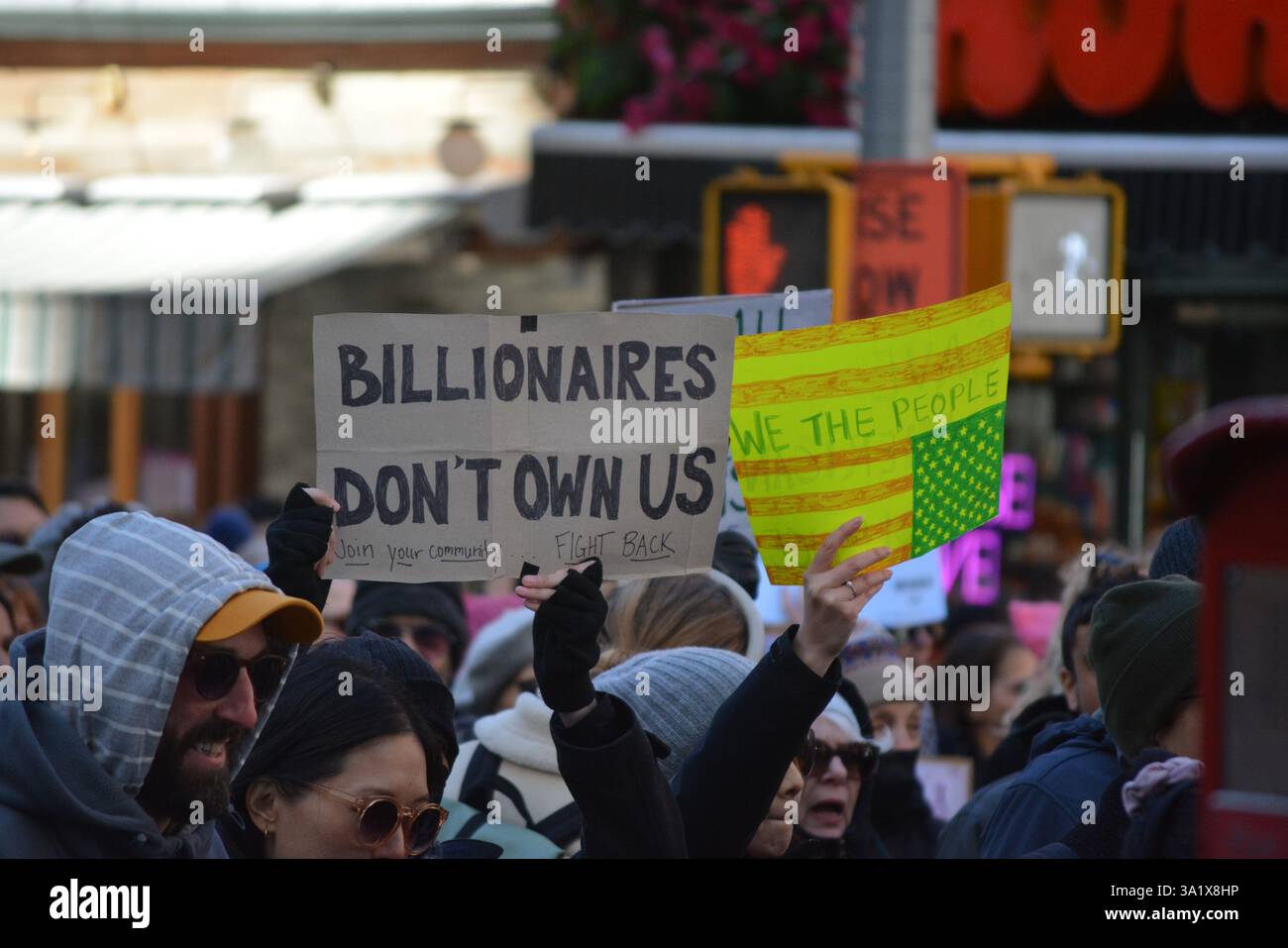 Anti-Elon Musk signs at an International Women's Day march in New York ...