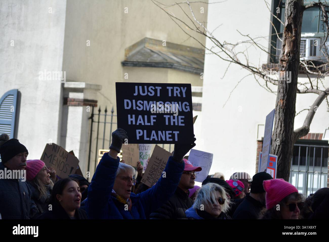 People holding signs at an International Women's Day march in New York ...
