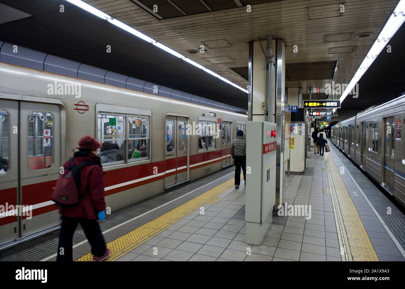 Subway trains waiting at a platform station on the Osaka underground ...