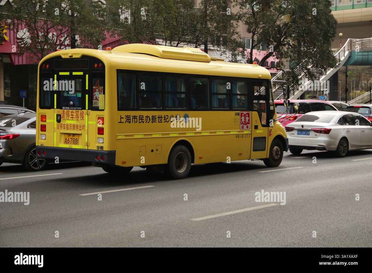 China, Shanghai. 7.08.2023. A yellow school bus on the street of a ...
