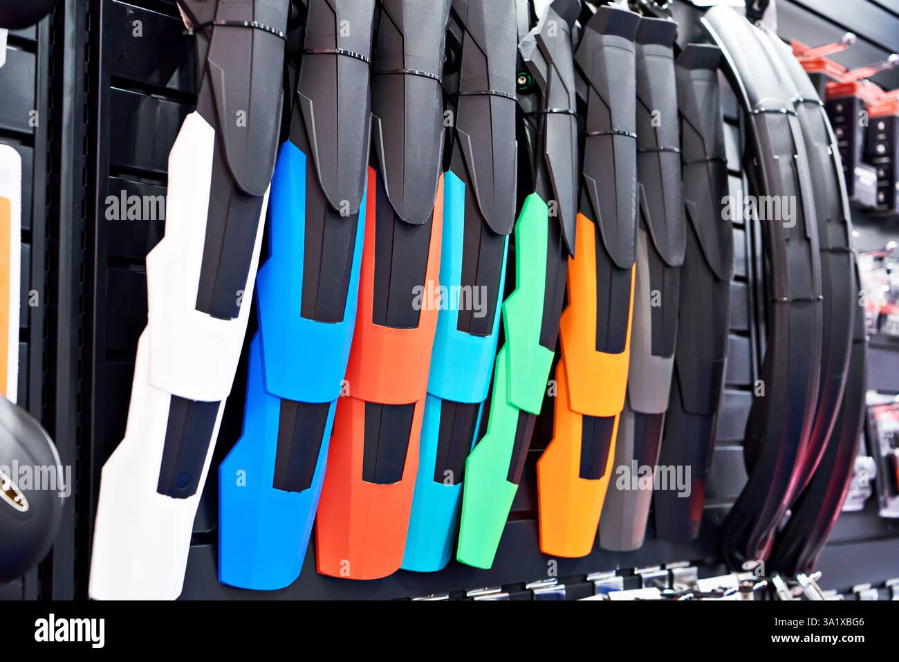 Colored plastic bike fenders in store Stock Photo - Alamy