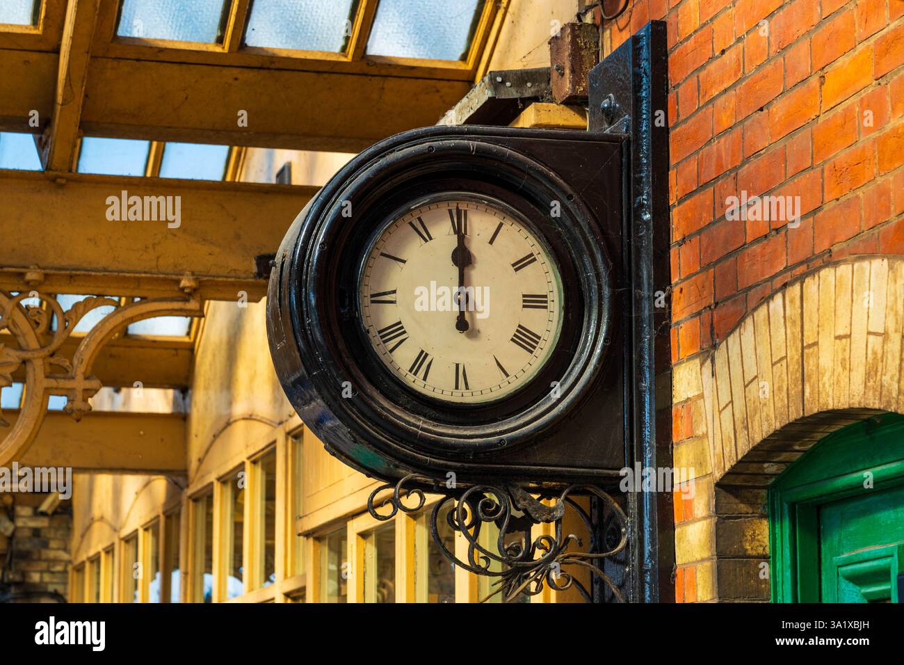 Retro antique clock at a train station, Old analog clock showing twelve o'clock Stock Photo - Alamy