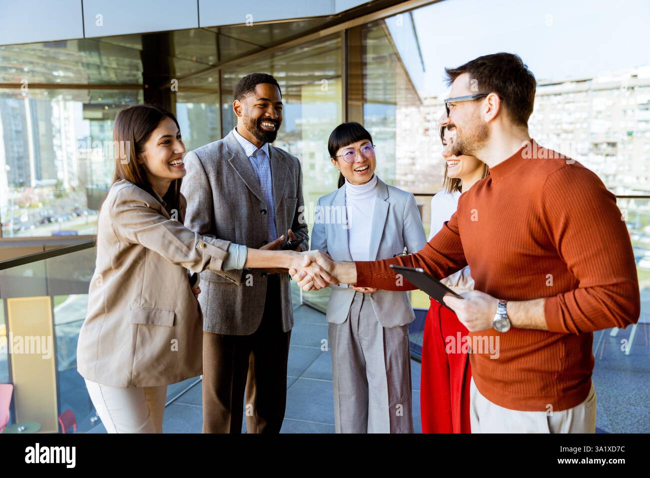 A group of professionals engages in a friendly handshake as they ...