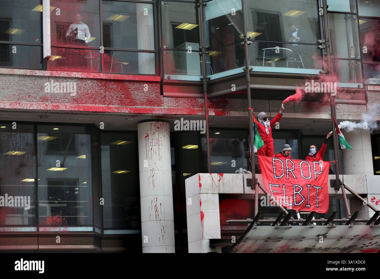 March 10, 2025, London, England, UK: Workers from inside the paint ...
