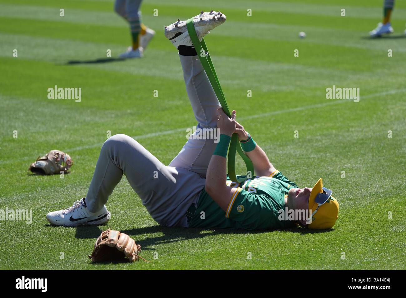 Athletics' Luke Mann warms up prior to a spring training baseball game ...