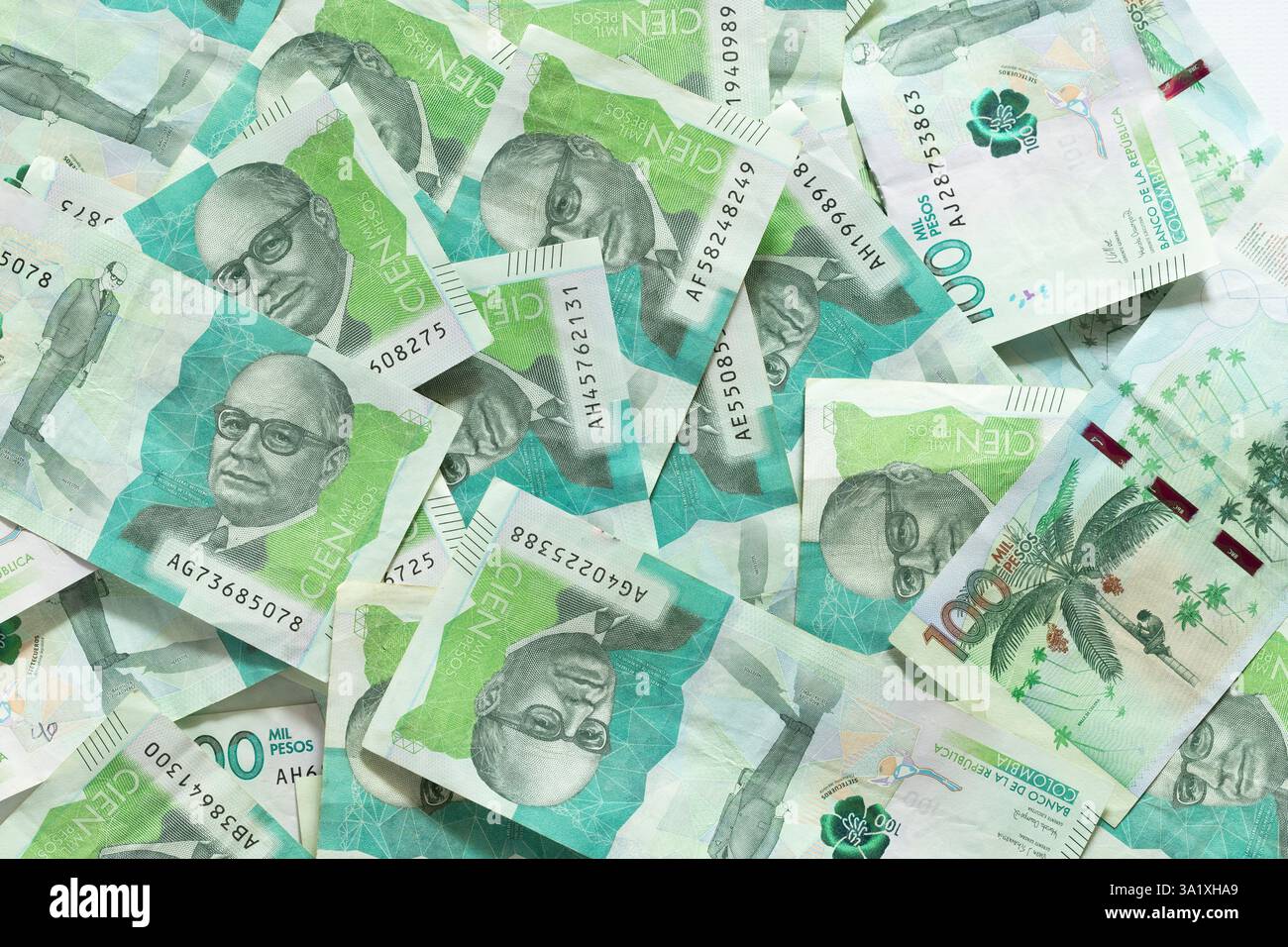 A pile of one hundred thousand Colombian peso bills is seen scattered ...