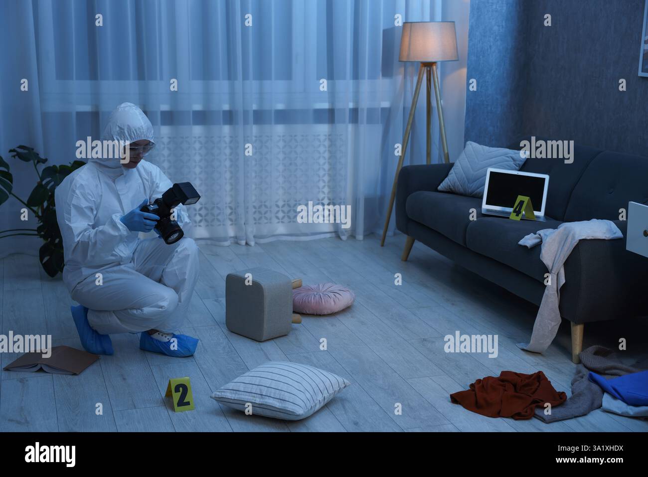 Forensic expert with camera working at crime scene in messy room Stock ...