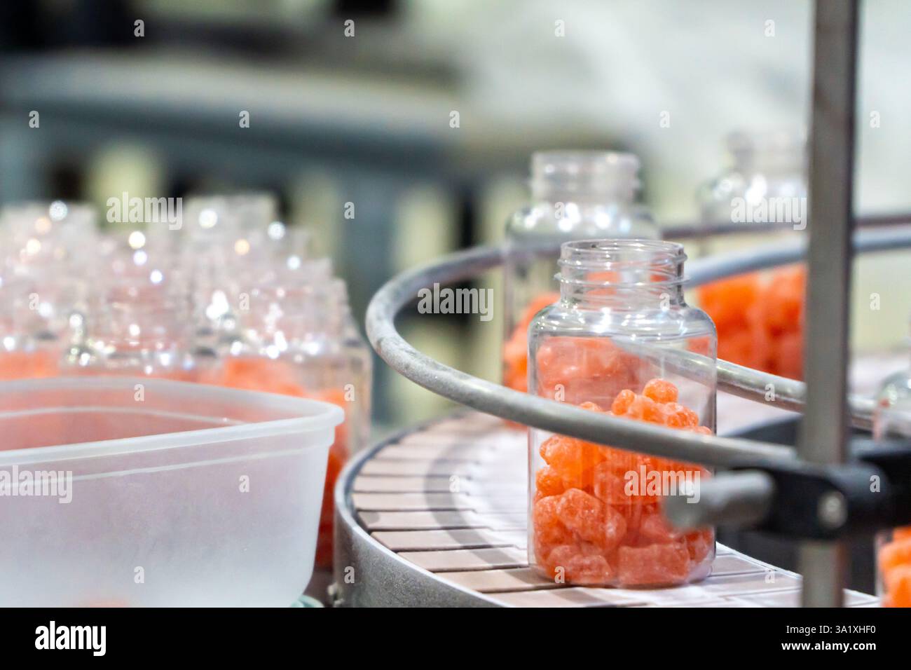 Nutritional supplement jars on the packaging process on a confectionery ...