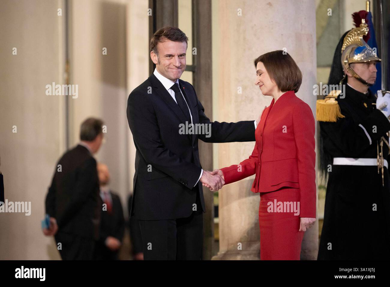French President Emmanuel Macron shakes hands with Moldova's President ...