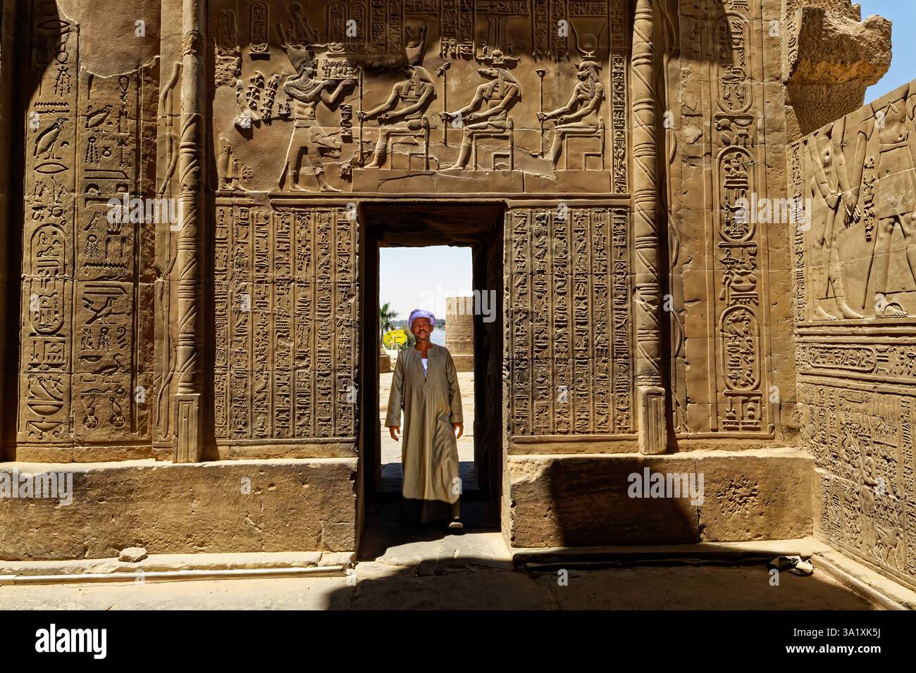 Guard standing in an entrance beneath a Ptolemaic bas relief at Kom ...