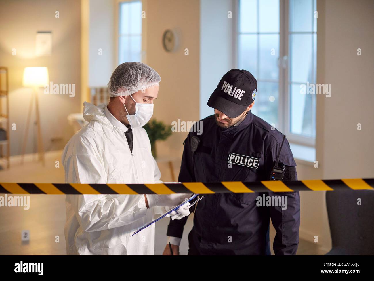 Forensic expert and police officer conduct investigation in victims ...