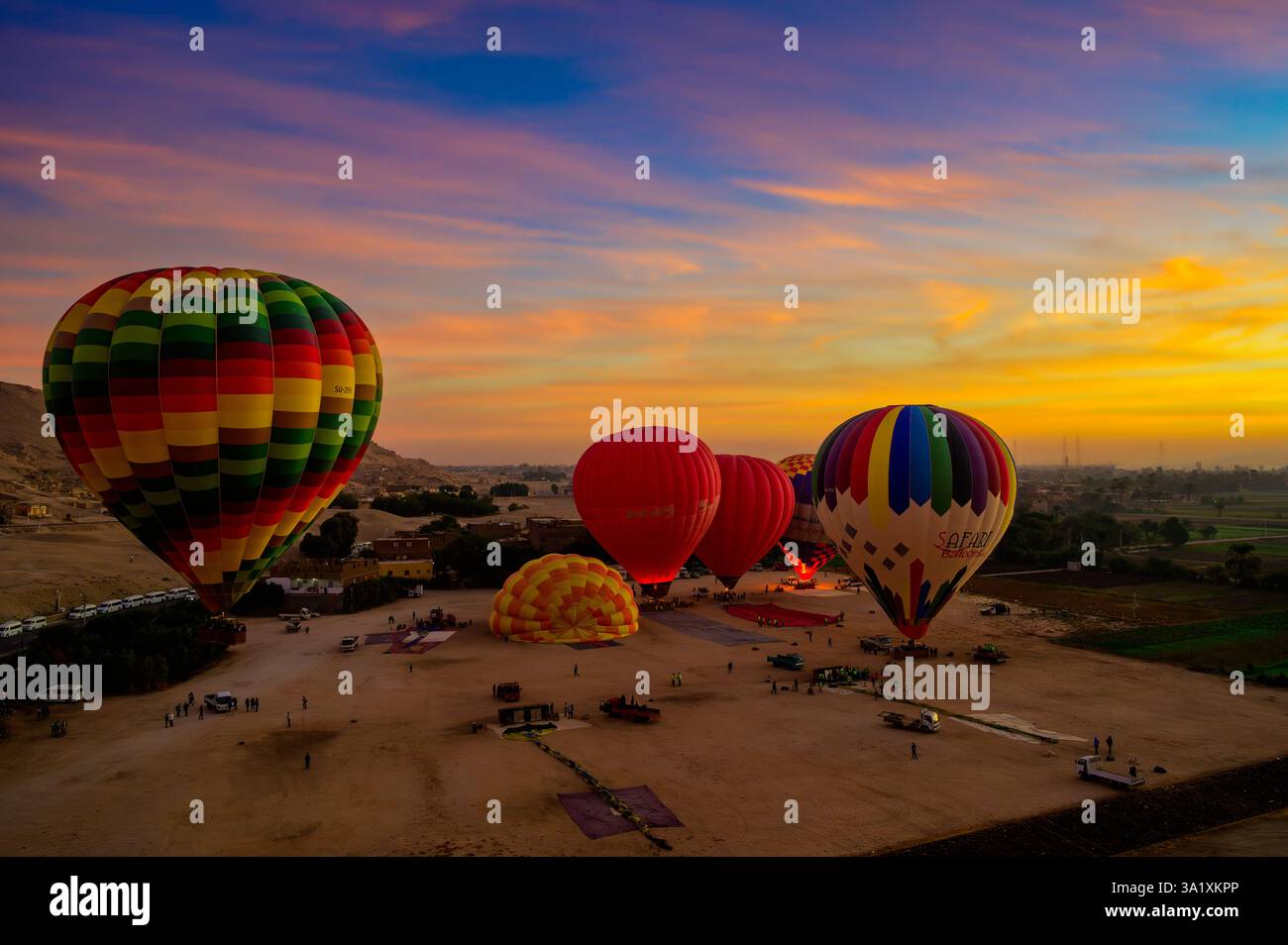 Inflated and half-inflated hot air balloons prepare to lift off for the ...