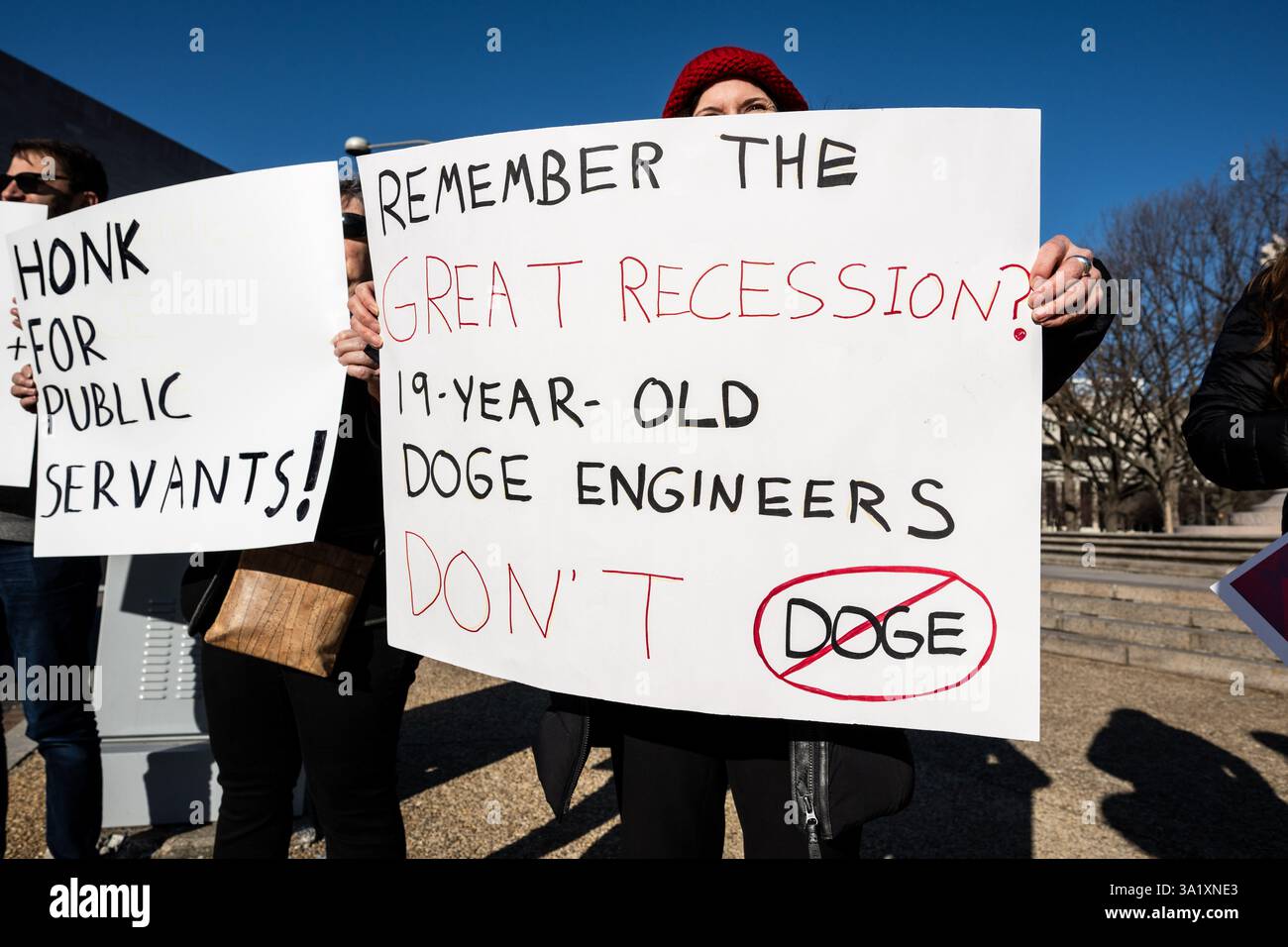Washington, United States. 10th Mar, 2025. People holding signs saying ...