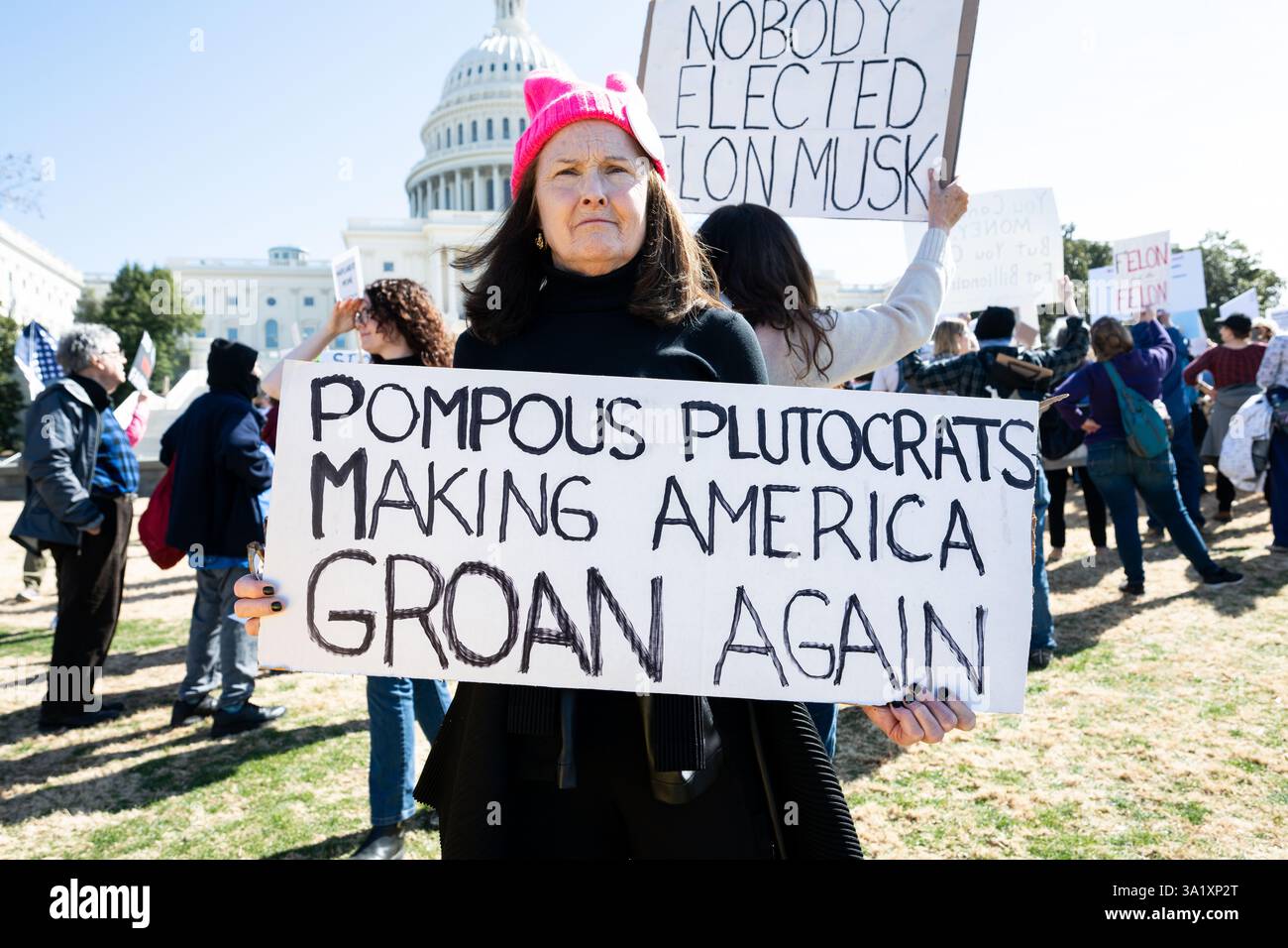 Washington, United States. 10th Mar, 2025. People holding signs saying ...