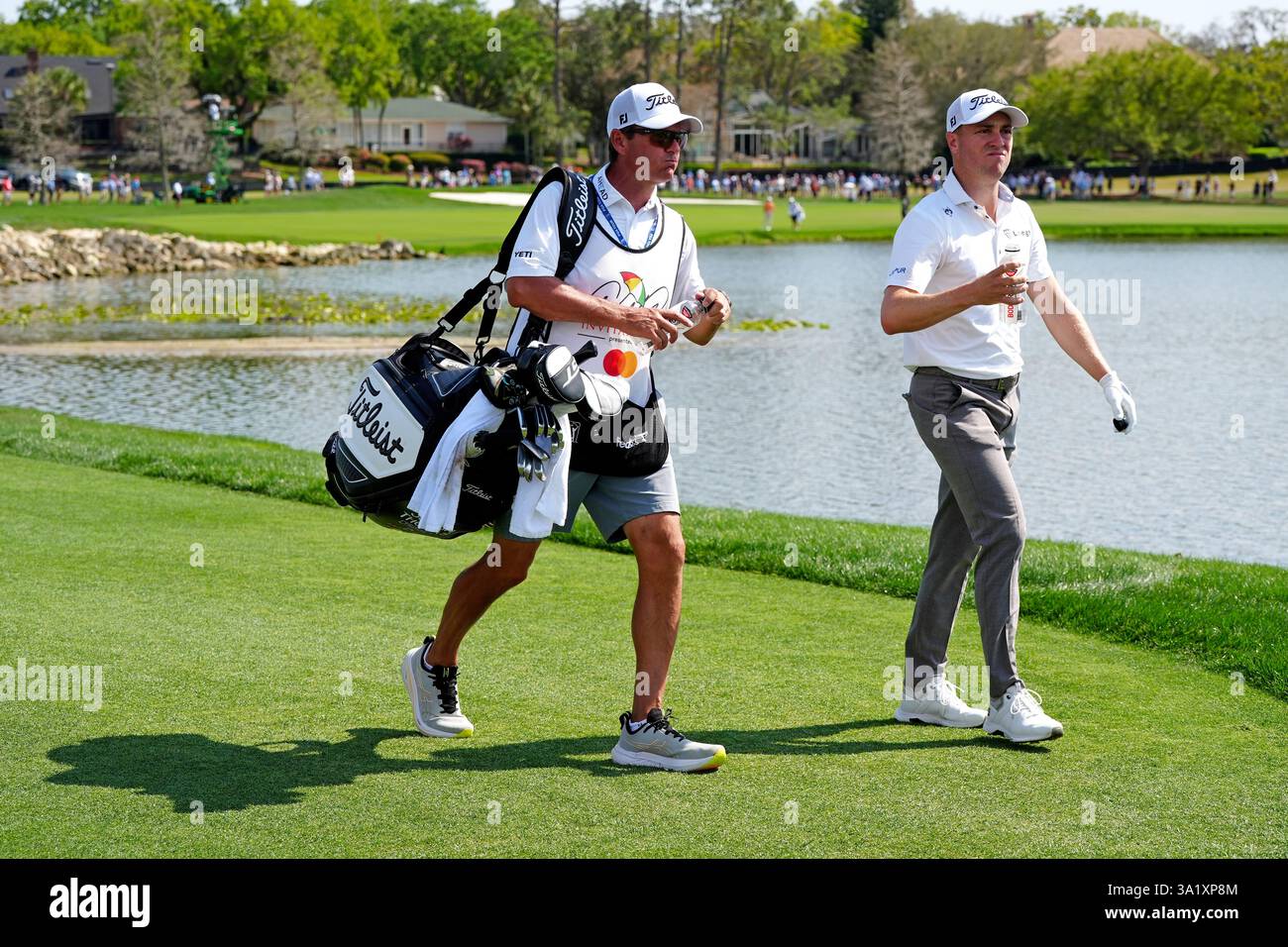 ORLANDO, FL - MARCH 08: PGA golfer Justin Thomas and his caddy walk the ...