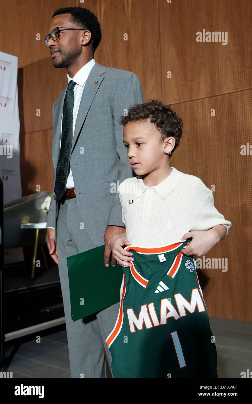 Jai Lucas, left, stands with his son Jaxin, right, after being ...