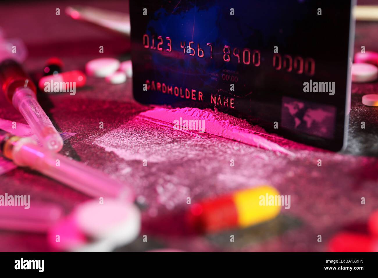 Drug addiction. Credit card, powder, pills and syringes on dark table ...