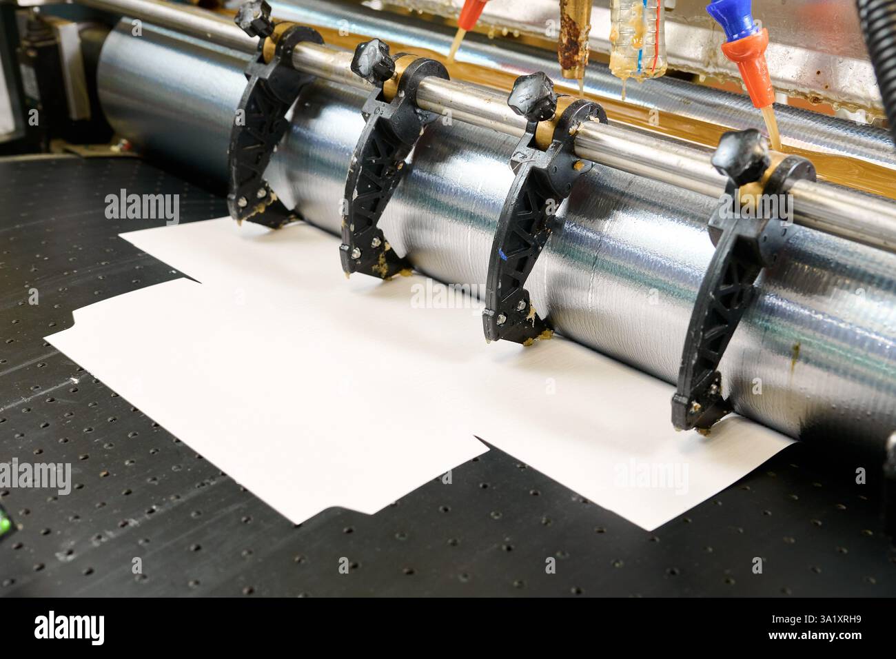 Innovative glue applicator in action spreads adhesive smoothly on a ...