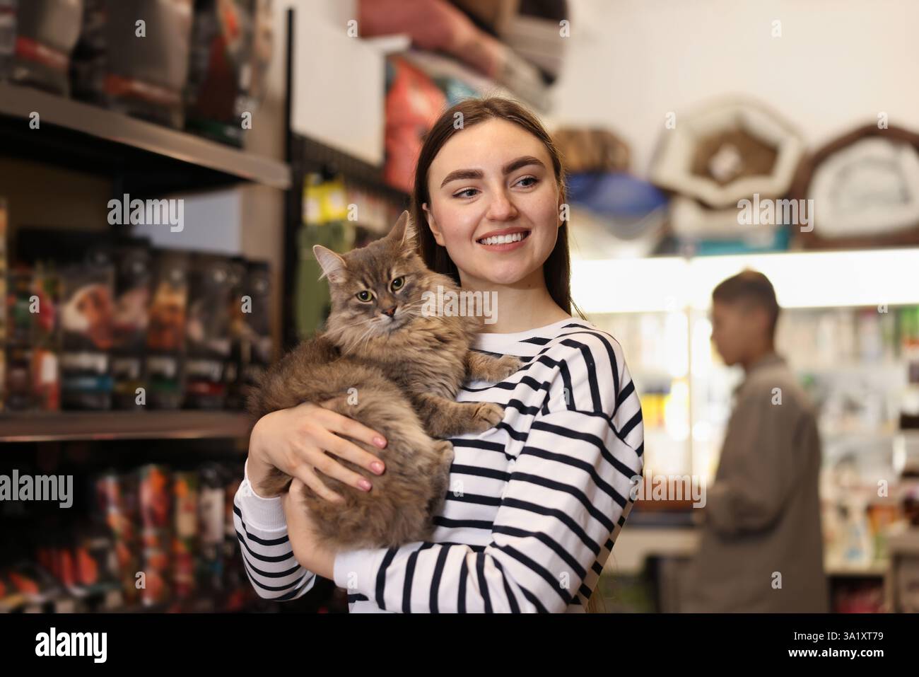 Woman with her cute cat in pet shop Stock Photo - Alamy