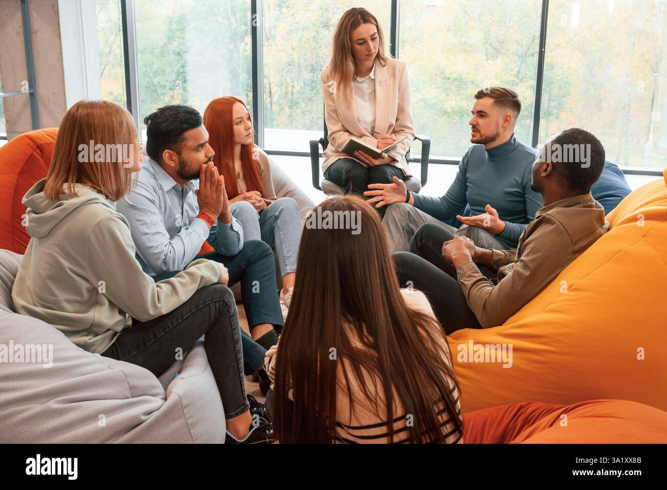 Psychologist is sitting and listening. Group of people are having ...