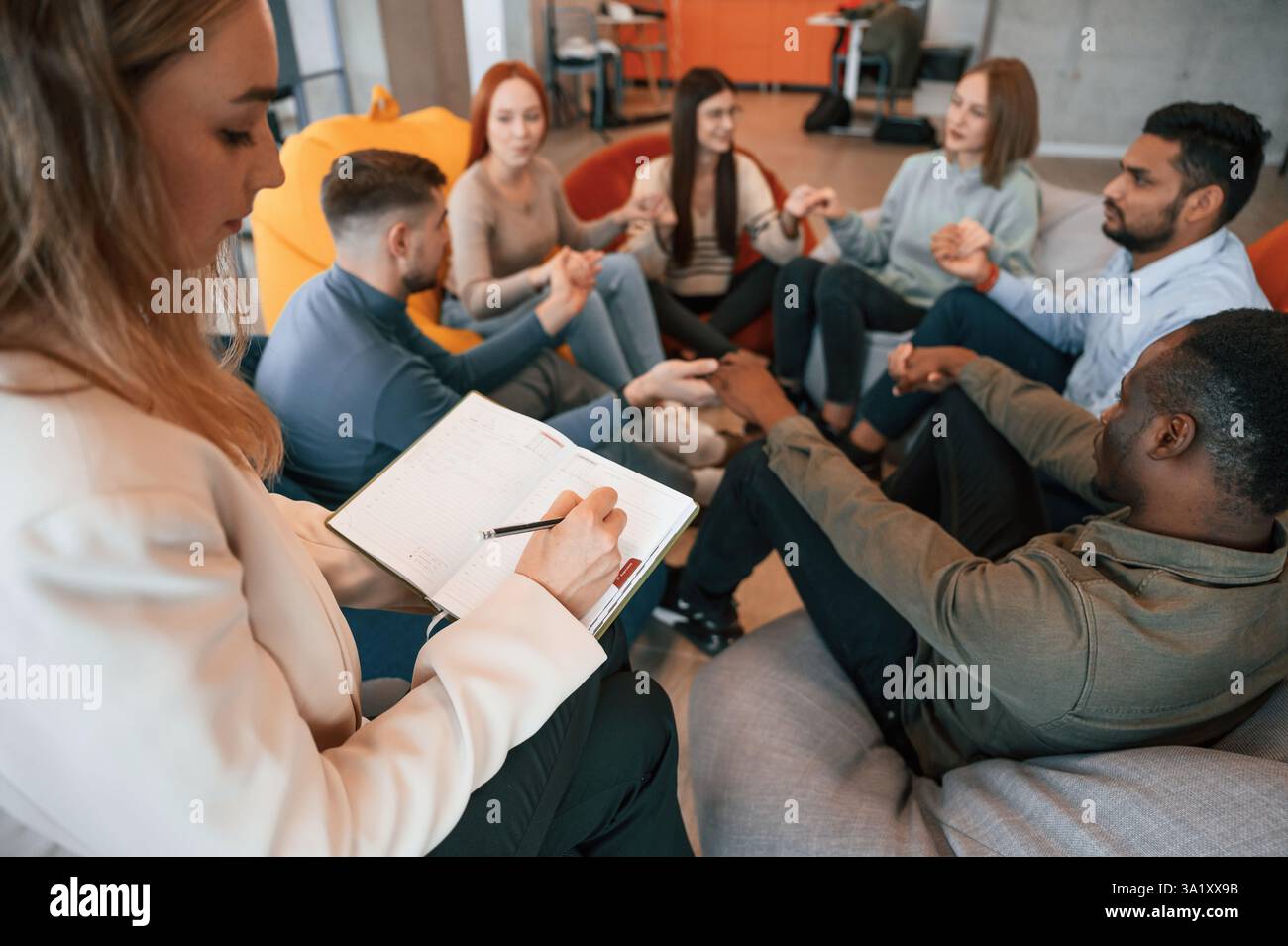 Psychologist is with notepad. Group of people are having therapy ...