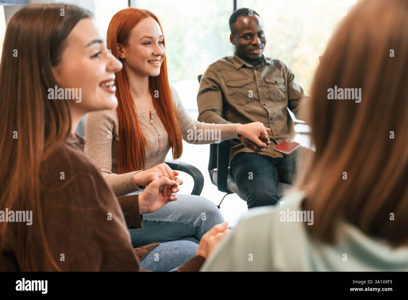 Calm and cheerful atmosphere. Group of people are having therapy ...