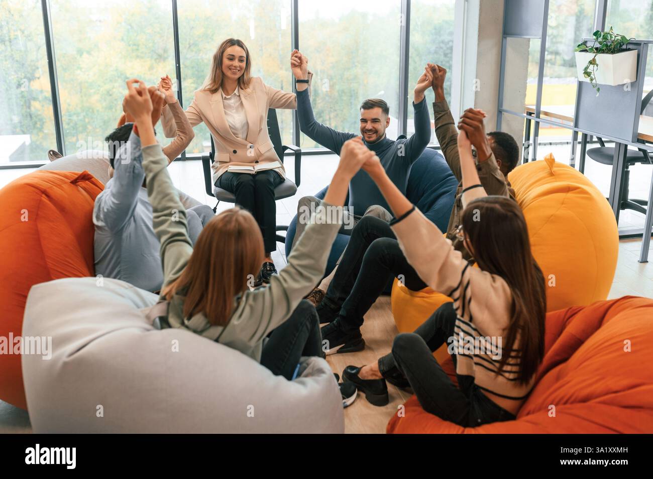 Calm and cheerful atmosphere. Group of people are having therapy ...