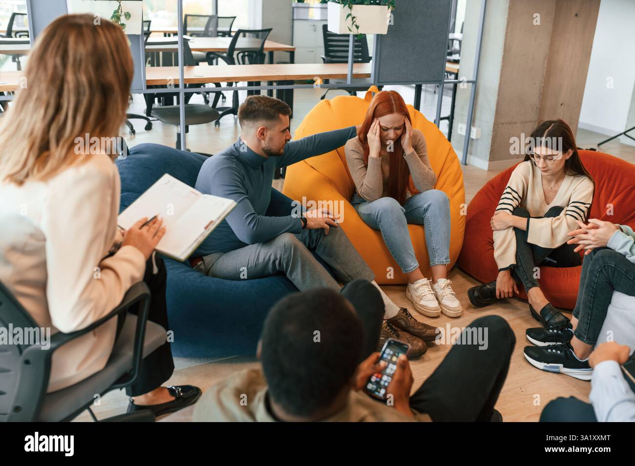 Woman needs help. Group of people are having therapy meeting together ...