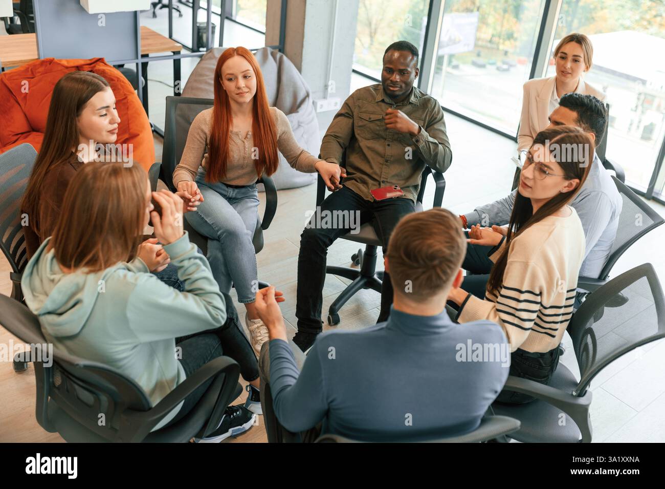 Therapy meeting in the circle together. Group of people Stock Photo - Alamy
