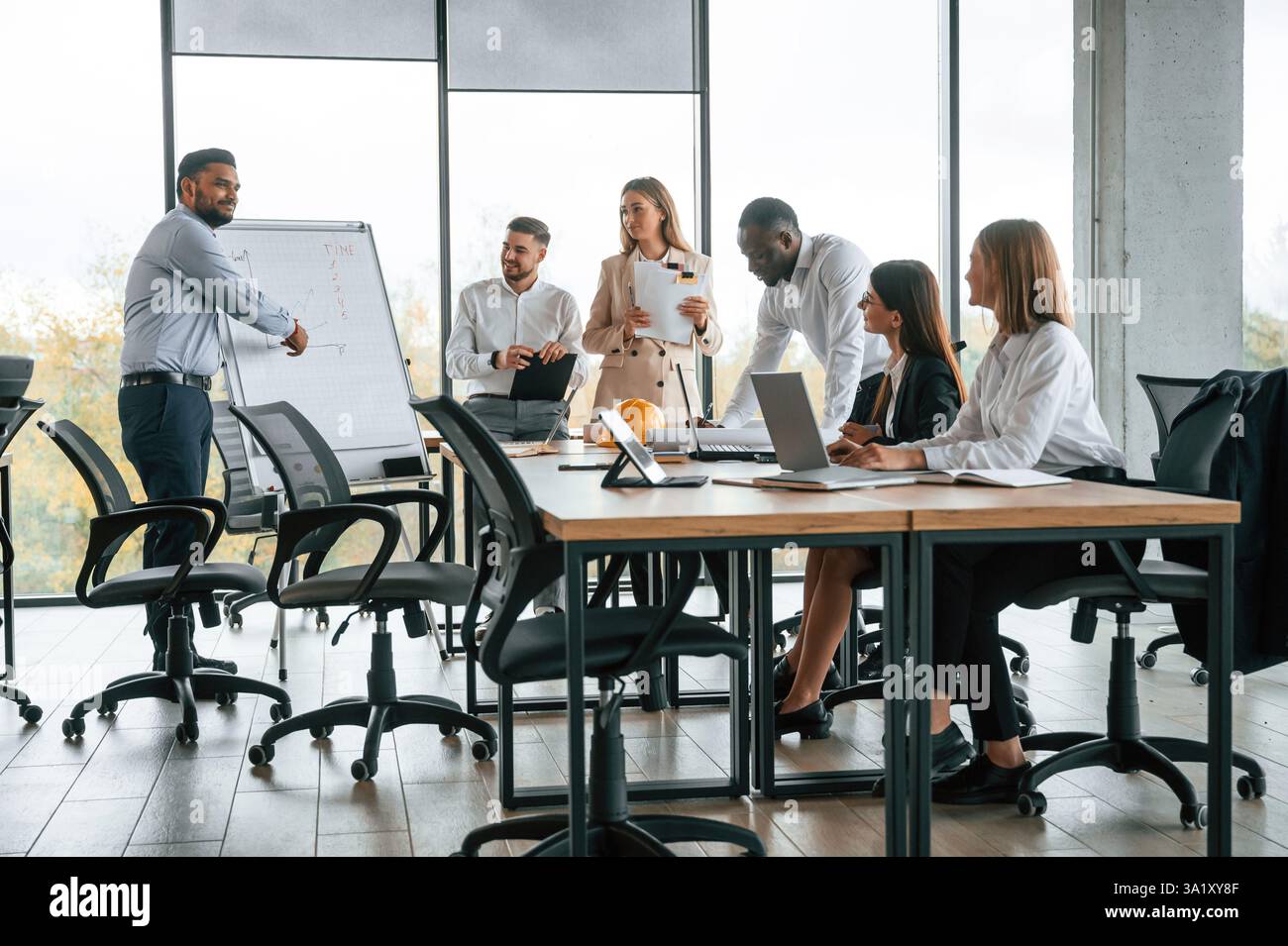 Business strategy on the whiteboard. Group of office workers are together indoors Stock Photo ...