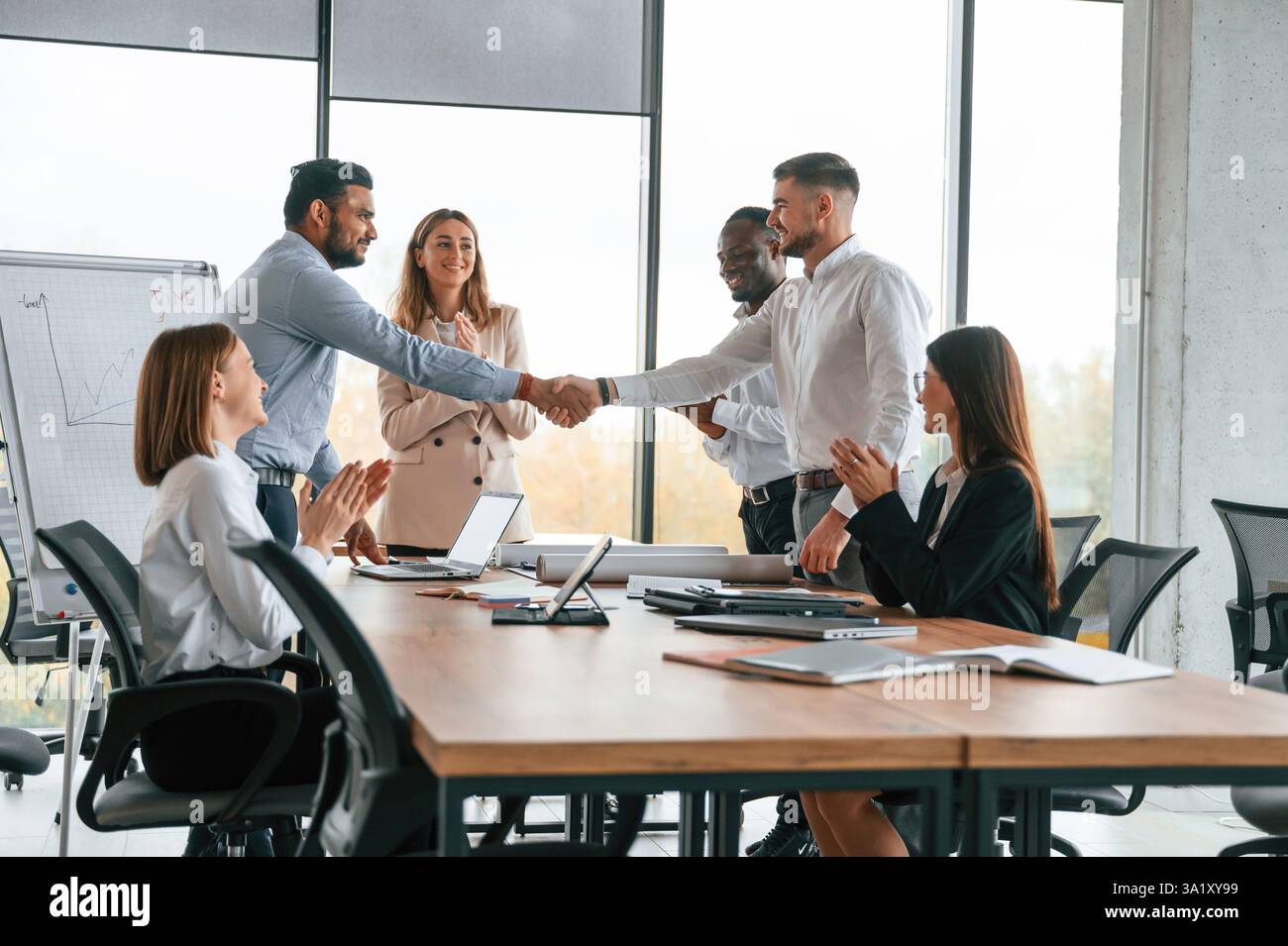 Successful agreement, making handshake. Group of office workers are ...