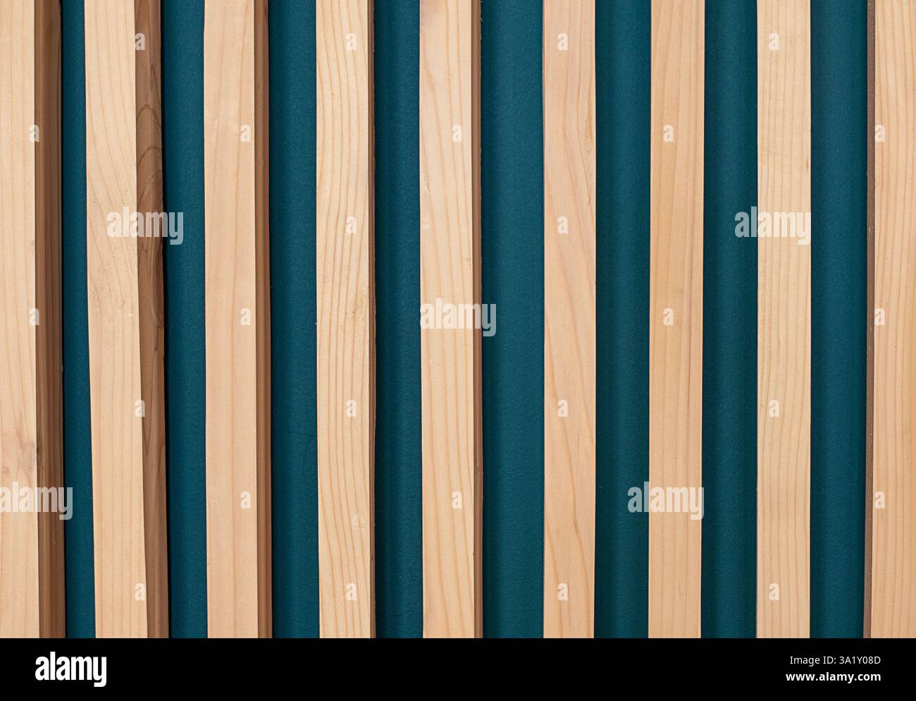 Wooden slats with green fabric creating a vertical linear pattern ...