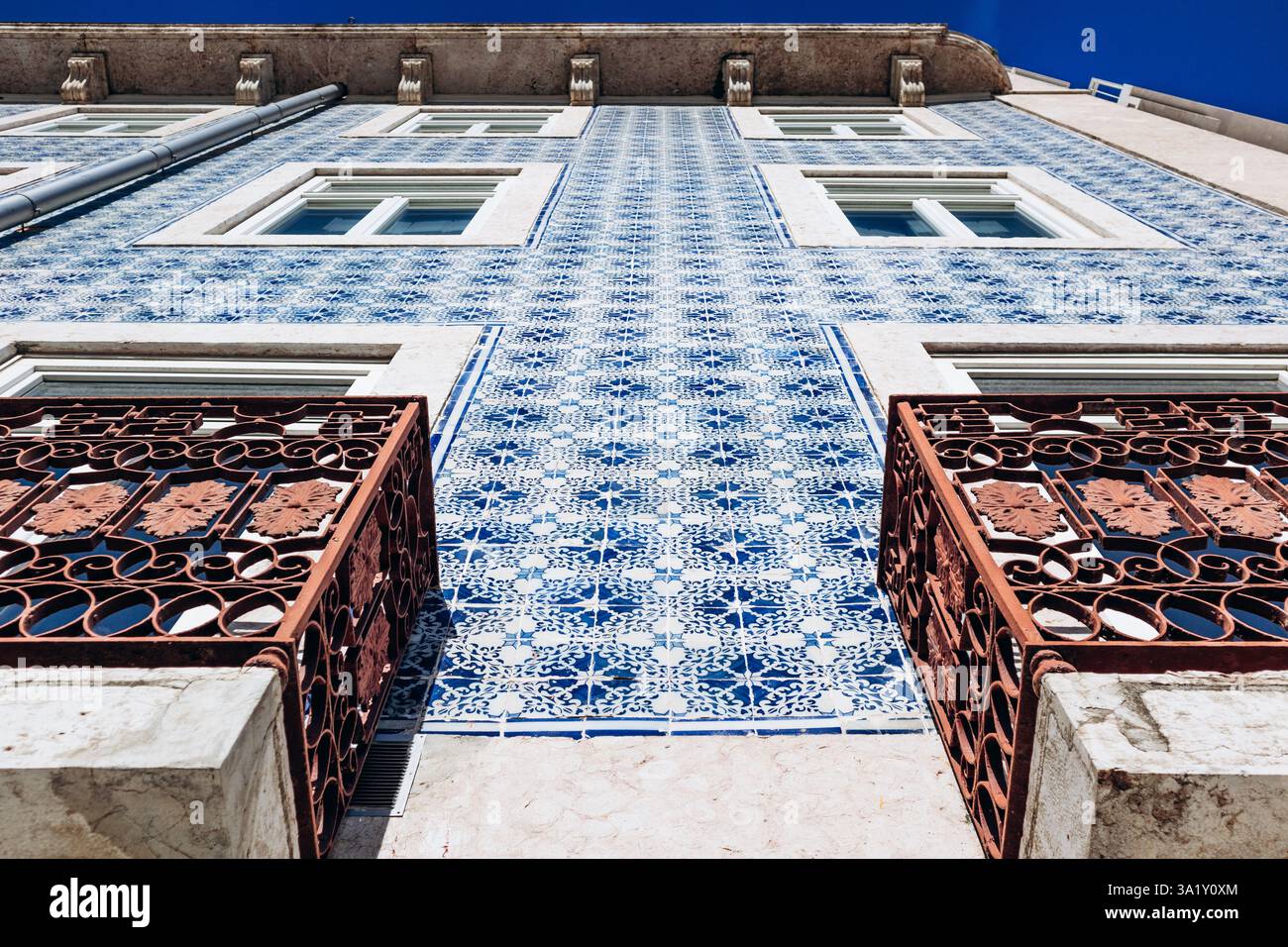 A historic facade in downtown Lisbon covered with iconic azulejo tiles ...