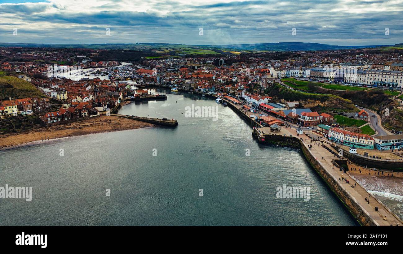 Aerial view of a coastal town featuring a harbor, beach, and ...