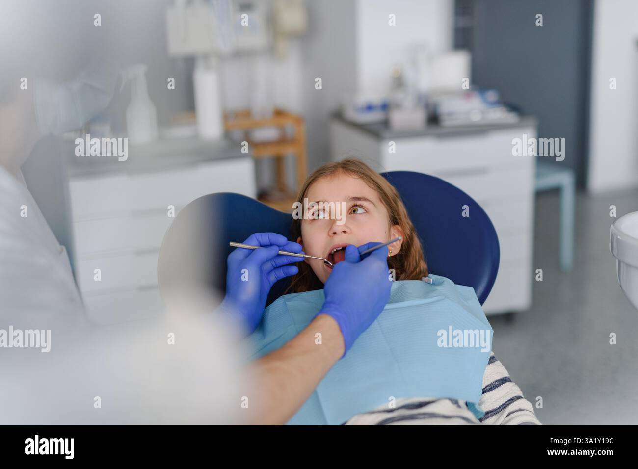 Cute girl during annual dental check-up in dental clinic Stock Photo ...