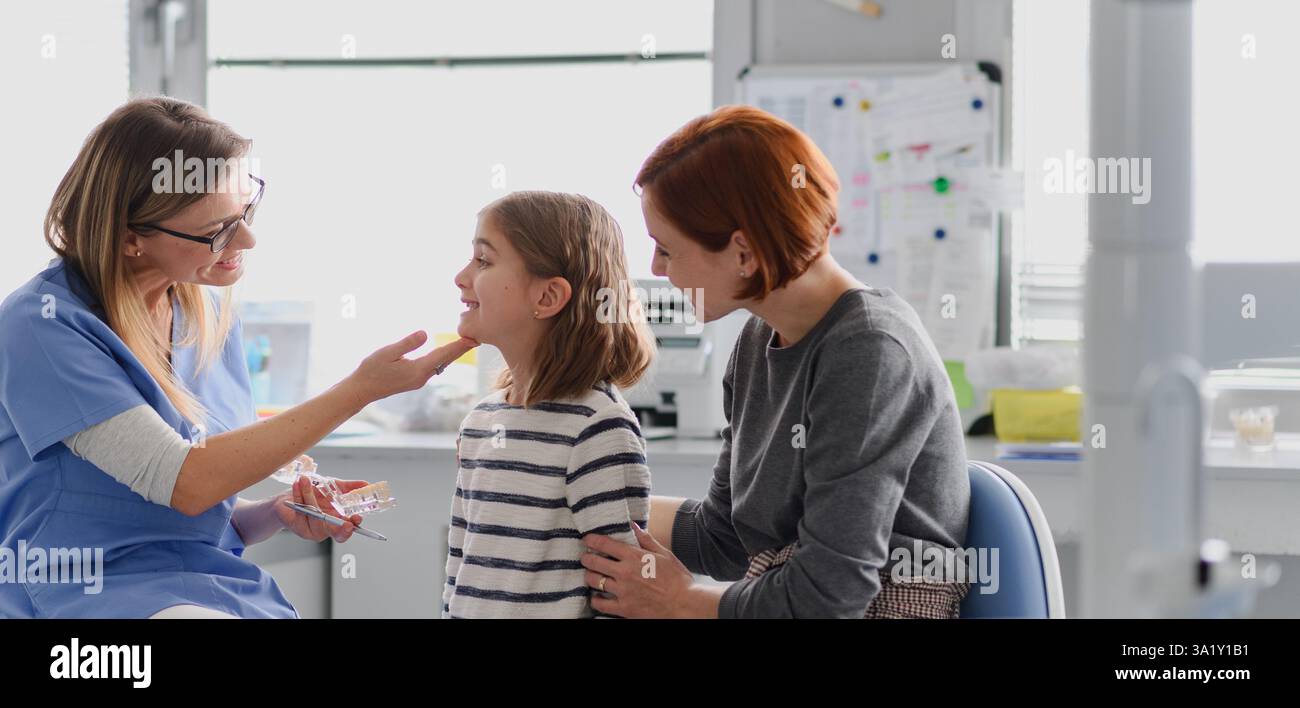 Girl is learning about toothcare during a routine checkup at the dental ...