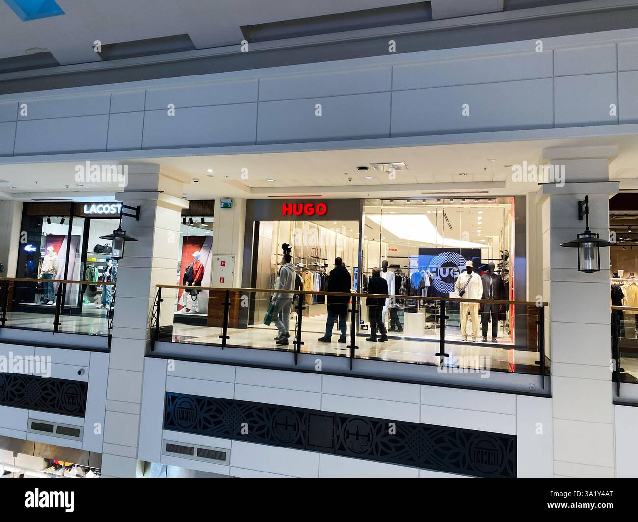 Warsaw, Poland - March 08, 2025: Contemporary shopping mall featuring popular brand stores and ...