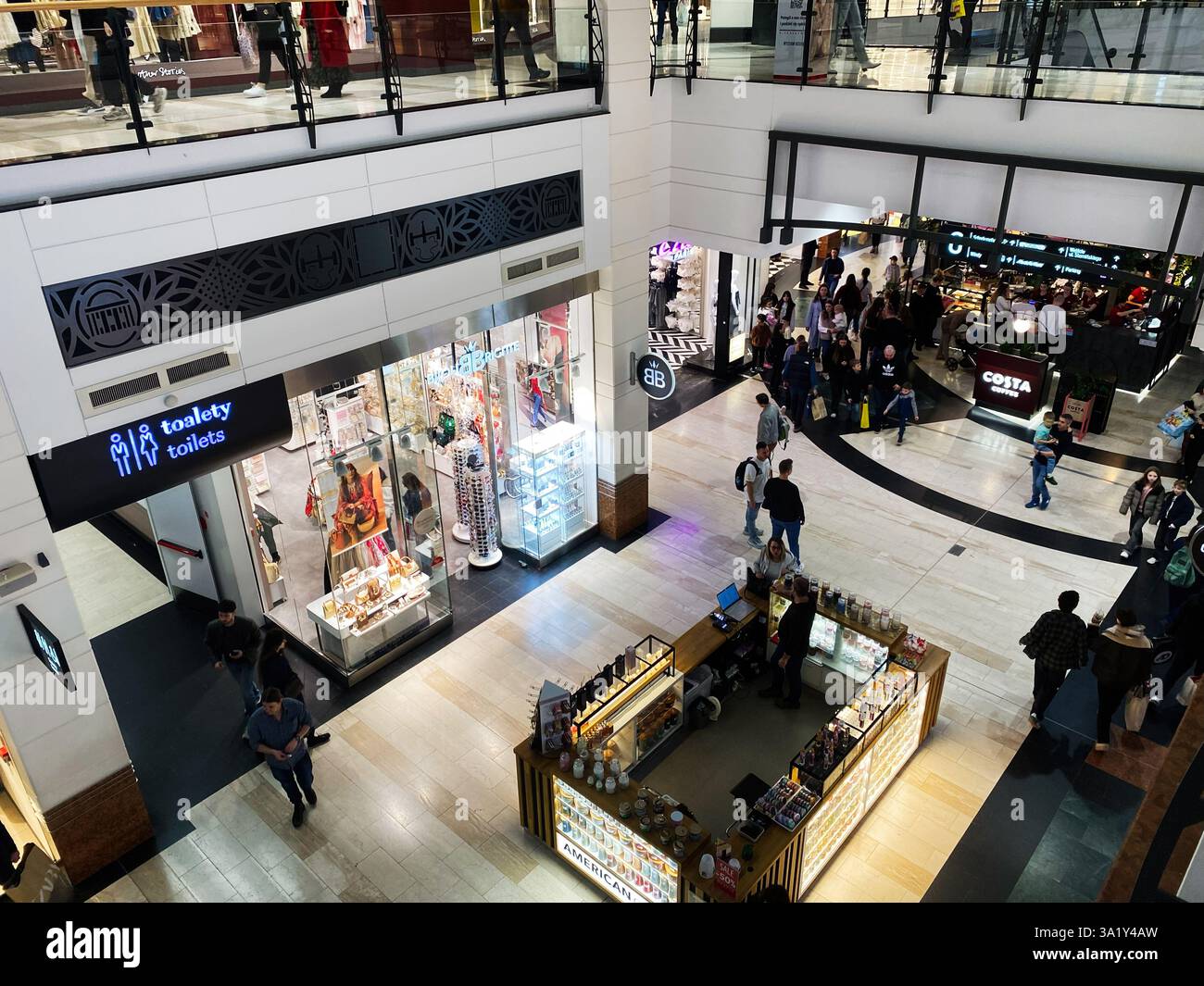 Warsaw, Poland - March 08, 2025: Busy Westfield Arkadia shopping mall interior showcasing ...