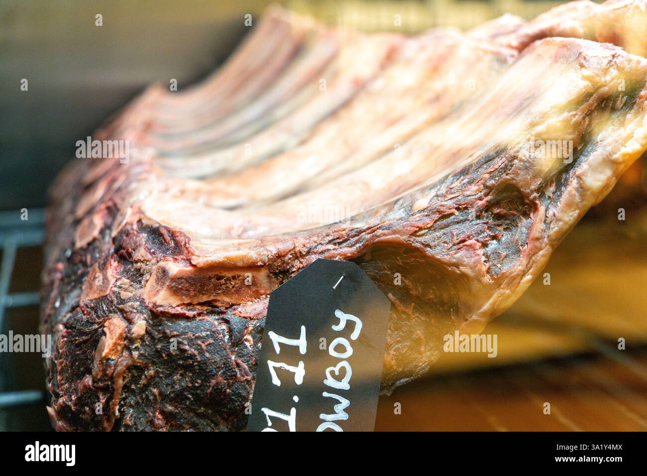 Marbled beef dry aging lies in the refrigerator in a restaurant. Dry aged beef meat, dry-aged ...
