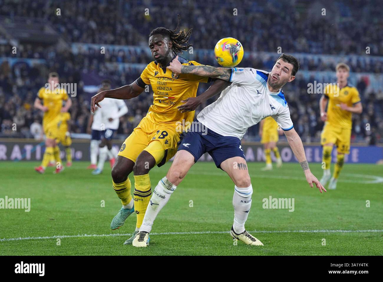 Udinese's Oumar Solet, left, and Lazio's Alessio Romagnoli challenge ...