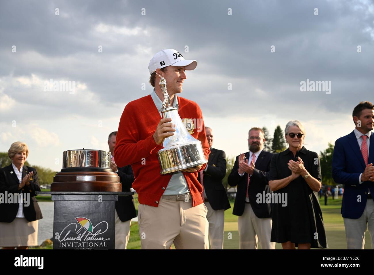 Russell Henley holds the championship trophy after winning the Arnold ...