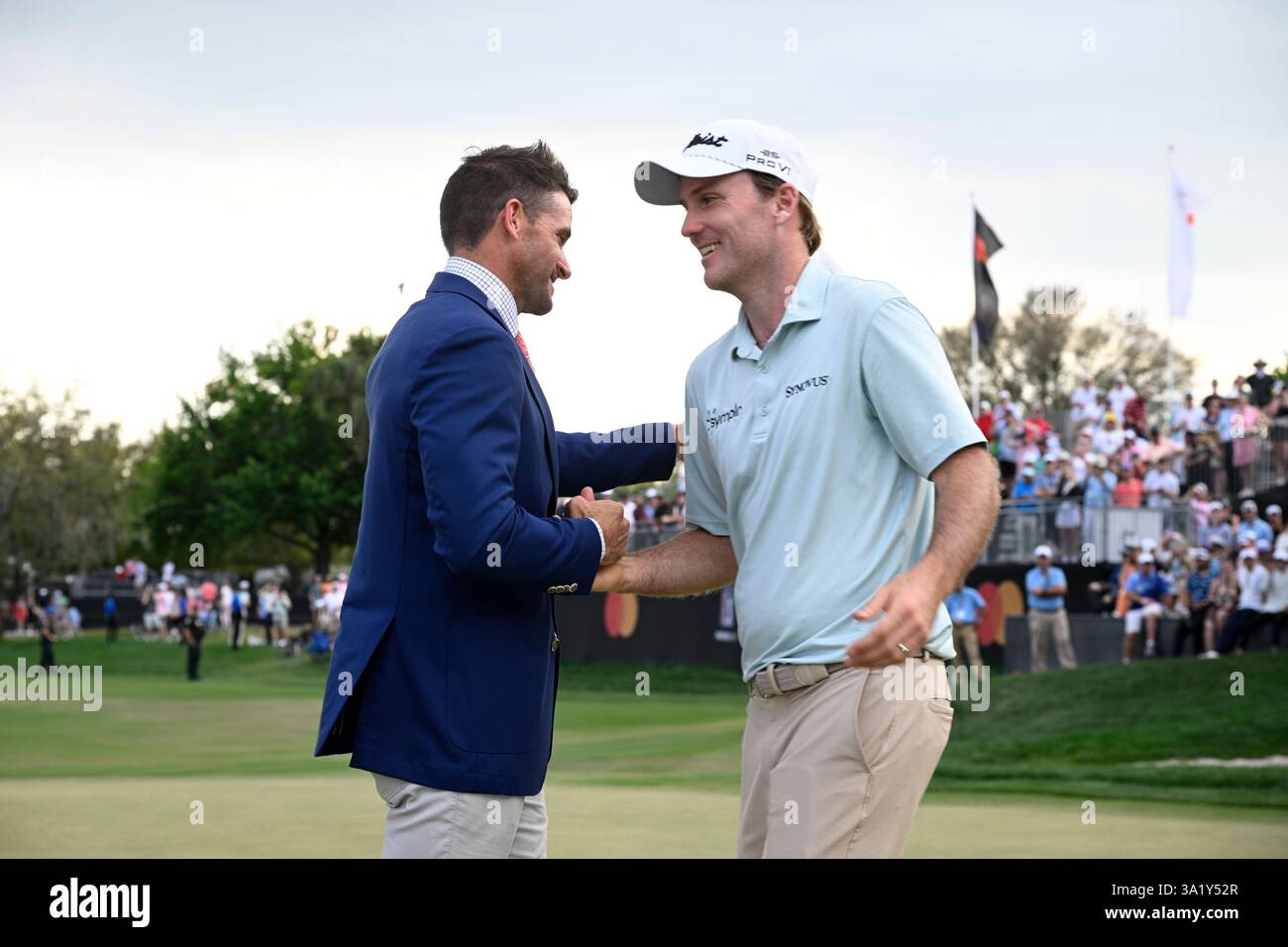Sam Saunders, left, greets Russell Henley on the 18th green during the ...