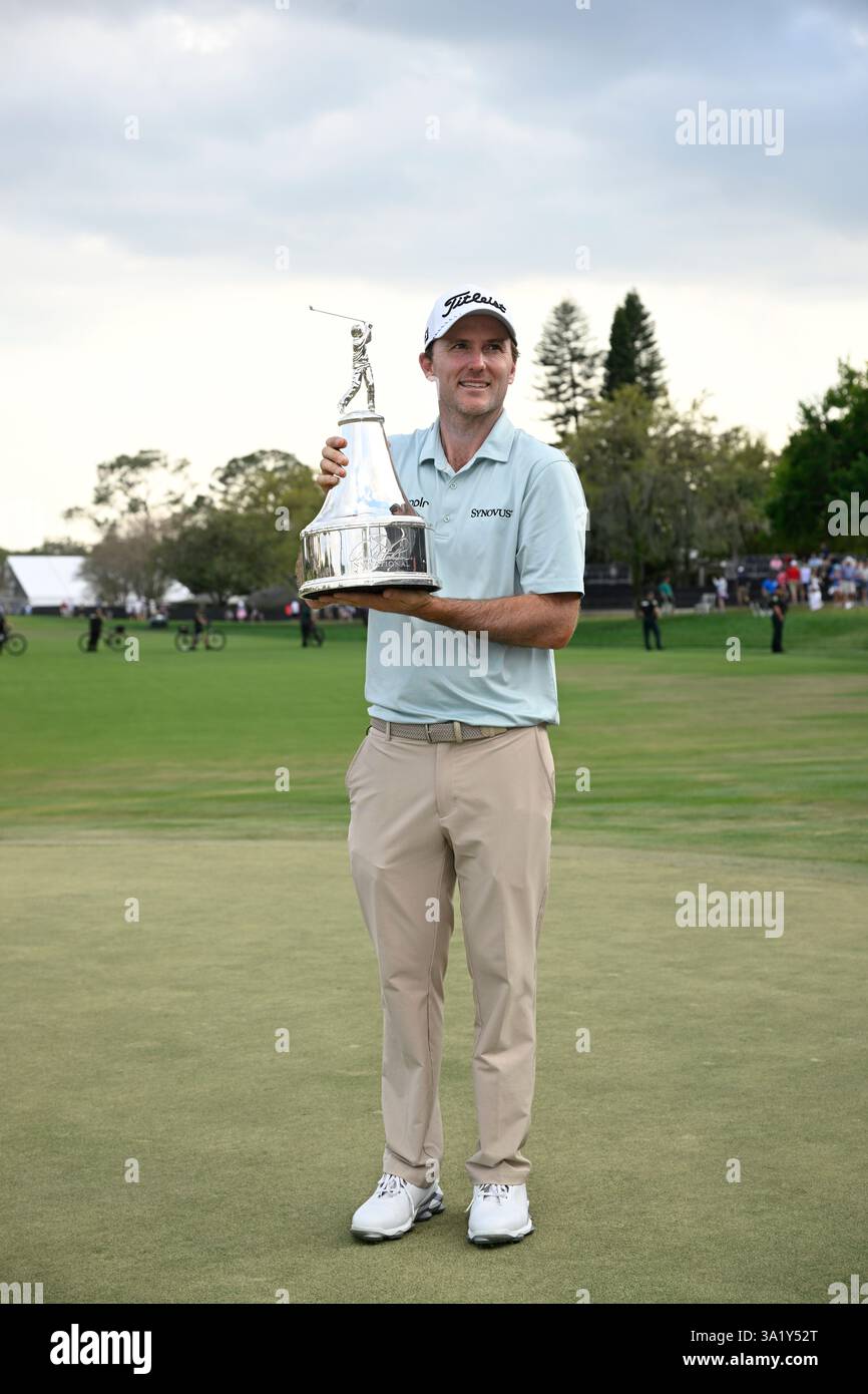 Russell Henley holds the championship trophy after winning the Arnold ...