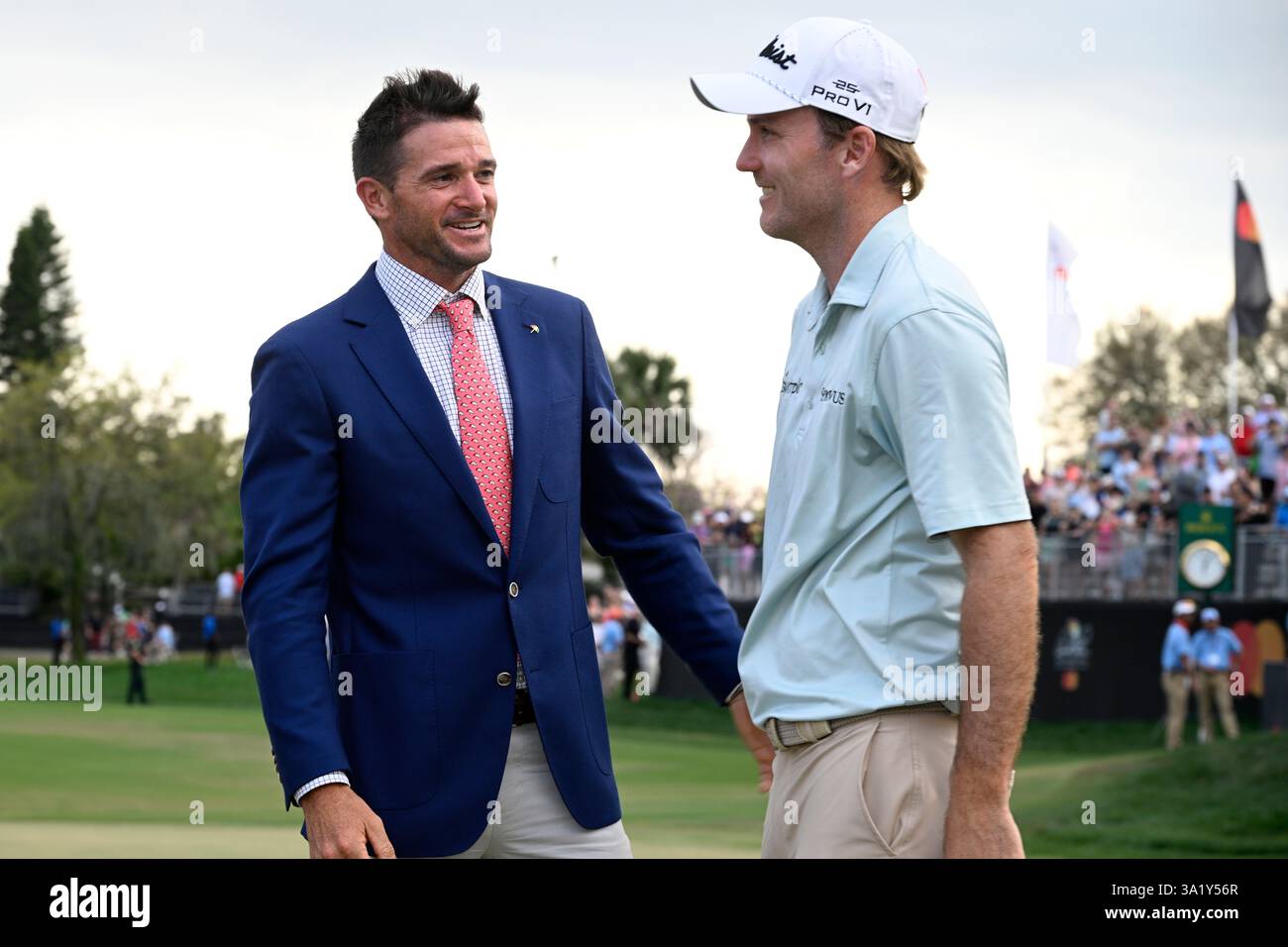 Sam Saunders, left, greets Russell Henley on the 18th green during the ...