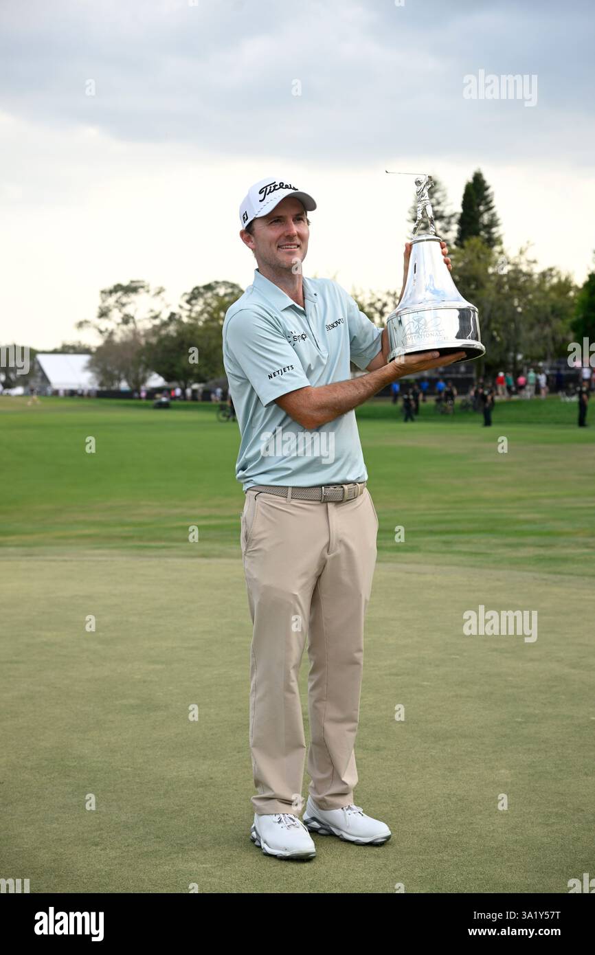 Russell Henley holds the championship trophy after winning the Arnold ...