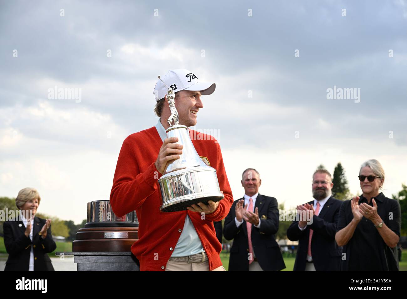 Russell Henley holds the championship trophy after winning the Arnold ...