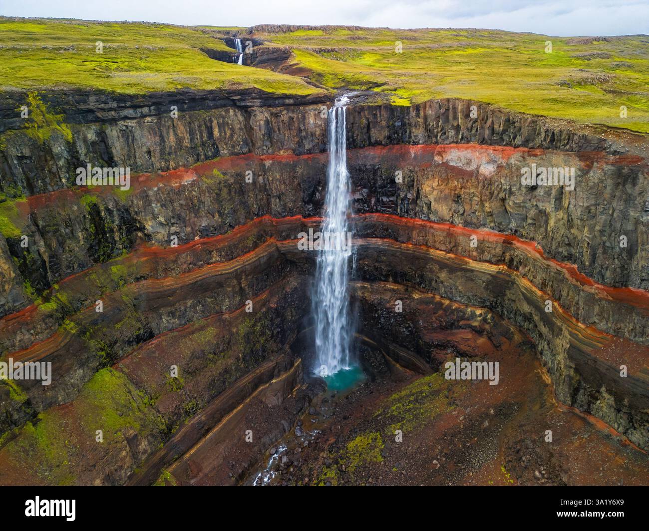 Aerial drone view of Hengifoss waterfall landscape in Iceland. Red ...