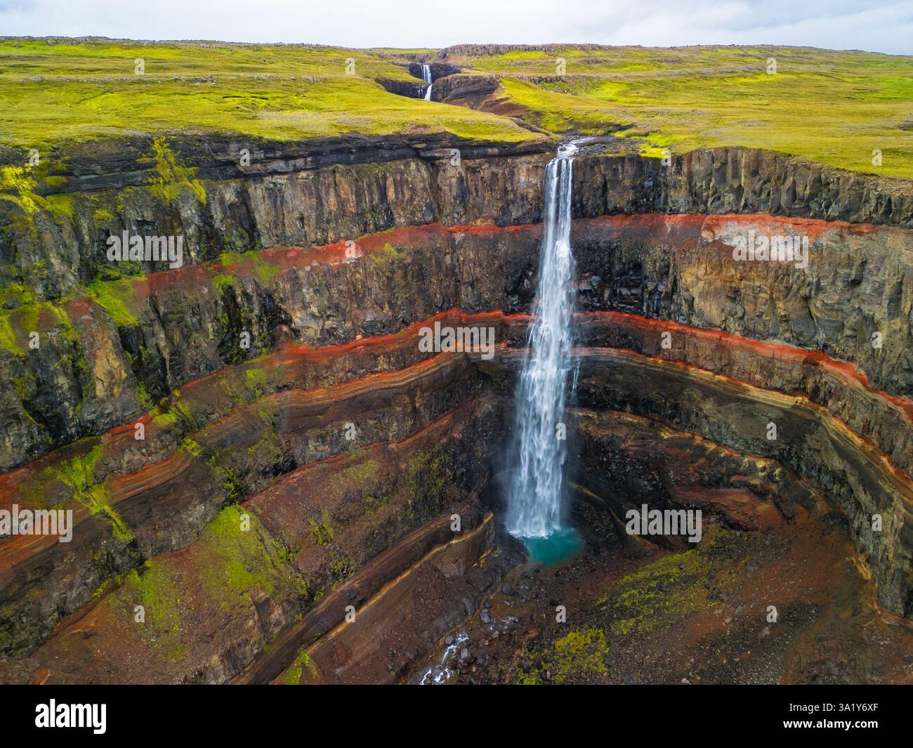 Aerial drone view of Hengifoss waterfall landscape in Iceland. Red ...